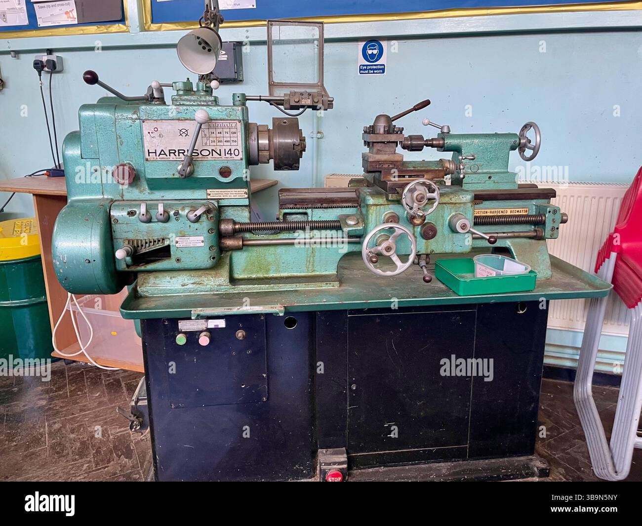 classic old wood working and metal working machinery in a classroom in ...