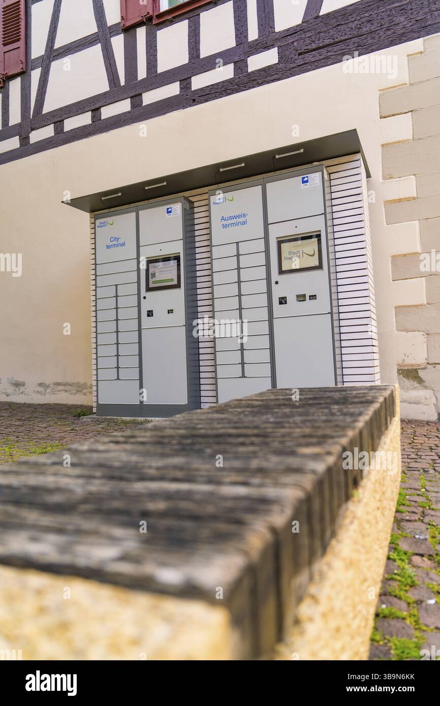 Modern parcel station with grey compartments in front of a half ...