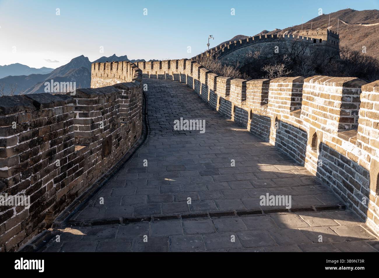 Stone path stretches endlessly along the ancient Great Wall, framed by ...