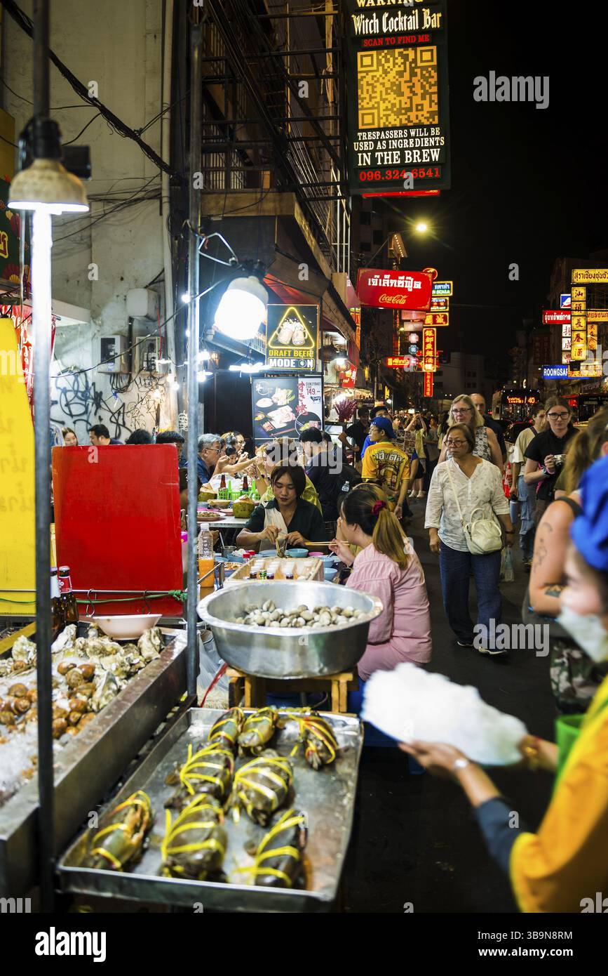 Shopping street with neon signs and street restaurants, nightlife ...
