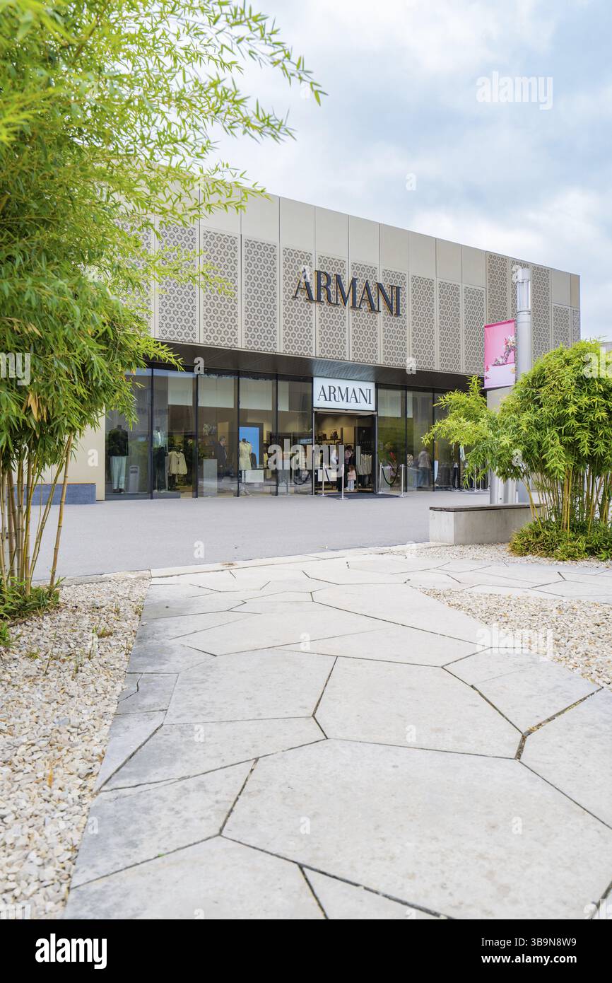 Armani shop in a modern shopping centre surrounded by pebbles and ...