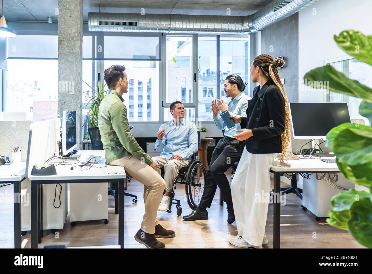 Businesspeople having a conversation in a modern office, demonstrating ...