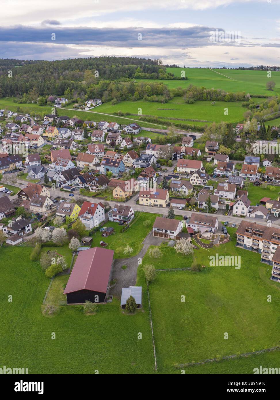 Overview of a village with scattered houses and large green spaces ...