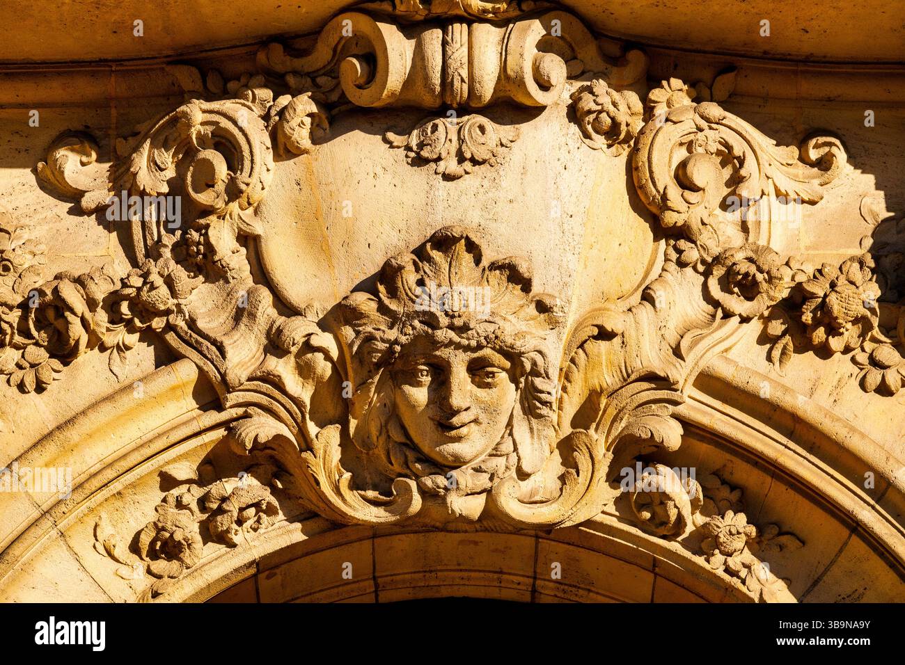Decorative female mascaron with floral motif above the entrance of the ...