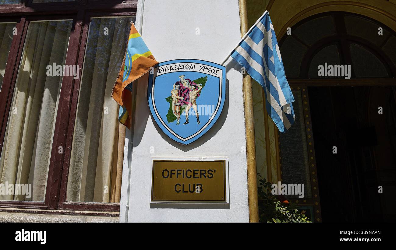 Building with sign of the officers' club, Greek flag and coat of arms ...