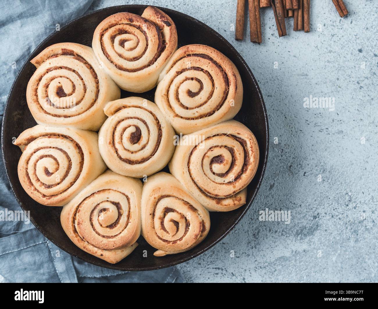 Idea and recipe pastries - perfect cinnamon rolls, top view in skillet ...