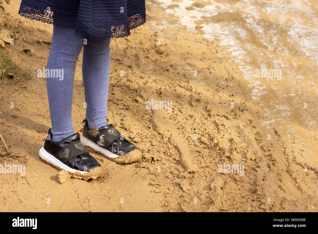 Child legs with shoes in mud outside Stock Photo - Alamy