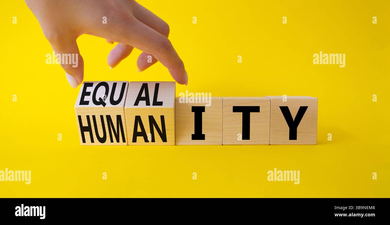 Equality and Humanity symbol. Businessman hand. Turned cubes with words ...