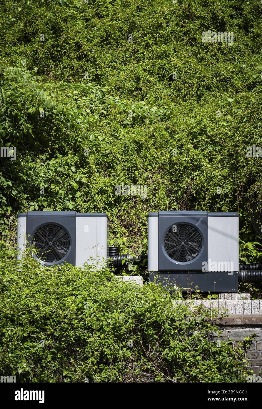 Two heat pumps are elevated on a wall in Wuppertal, Germany, Europe ...