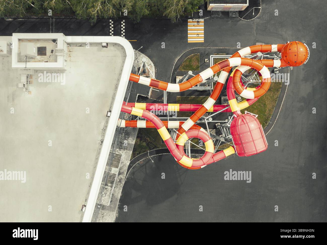 Aerial top down view of colorful winding slides of an attraction in ...