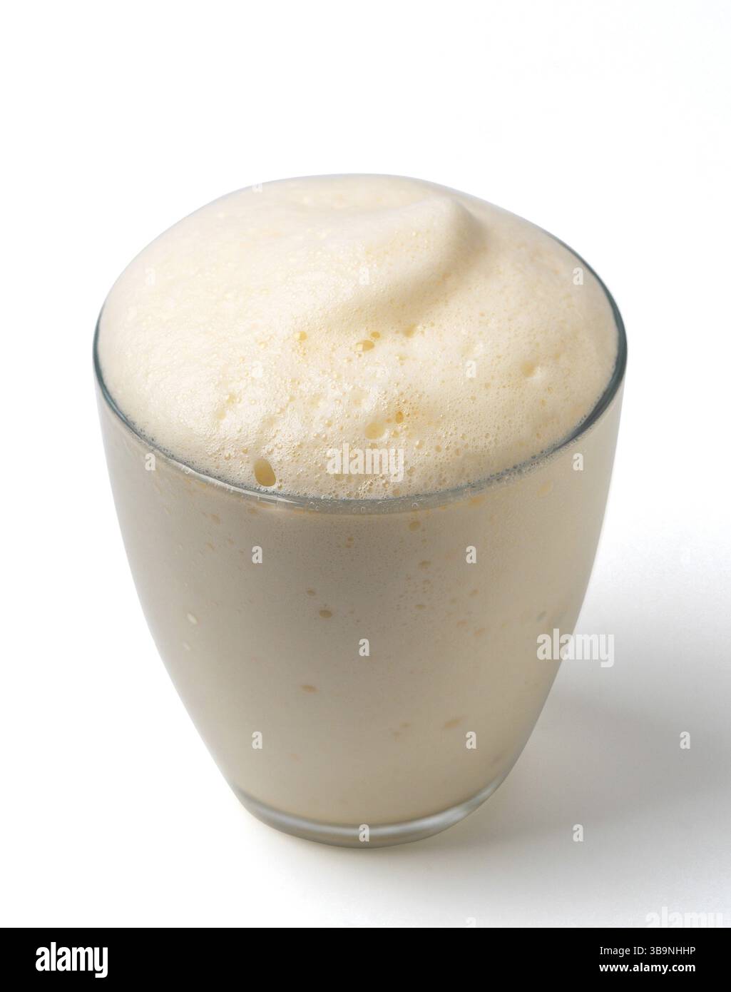 Vanilla milkshake with foam isolated on white. Delicious milk dessert ...