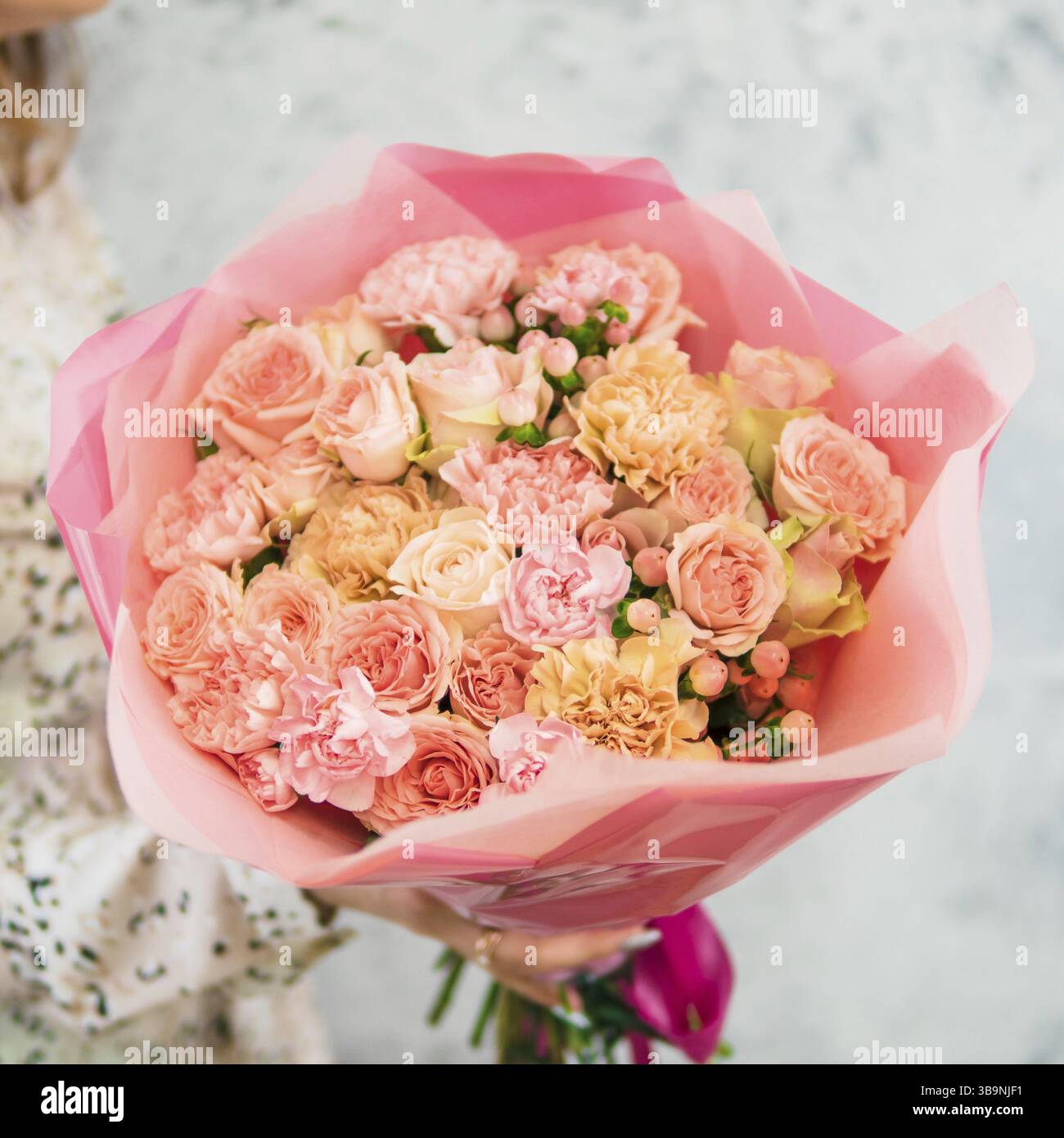 Beautiful bouquet with differen tpink flowers in woman hands. Nice ...