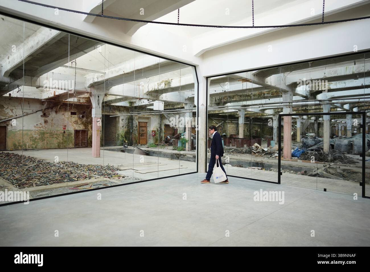 A visitor looks around the Museum of Survivors, located in a factory ...