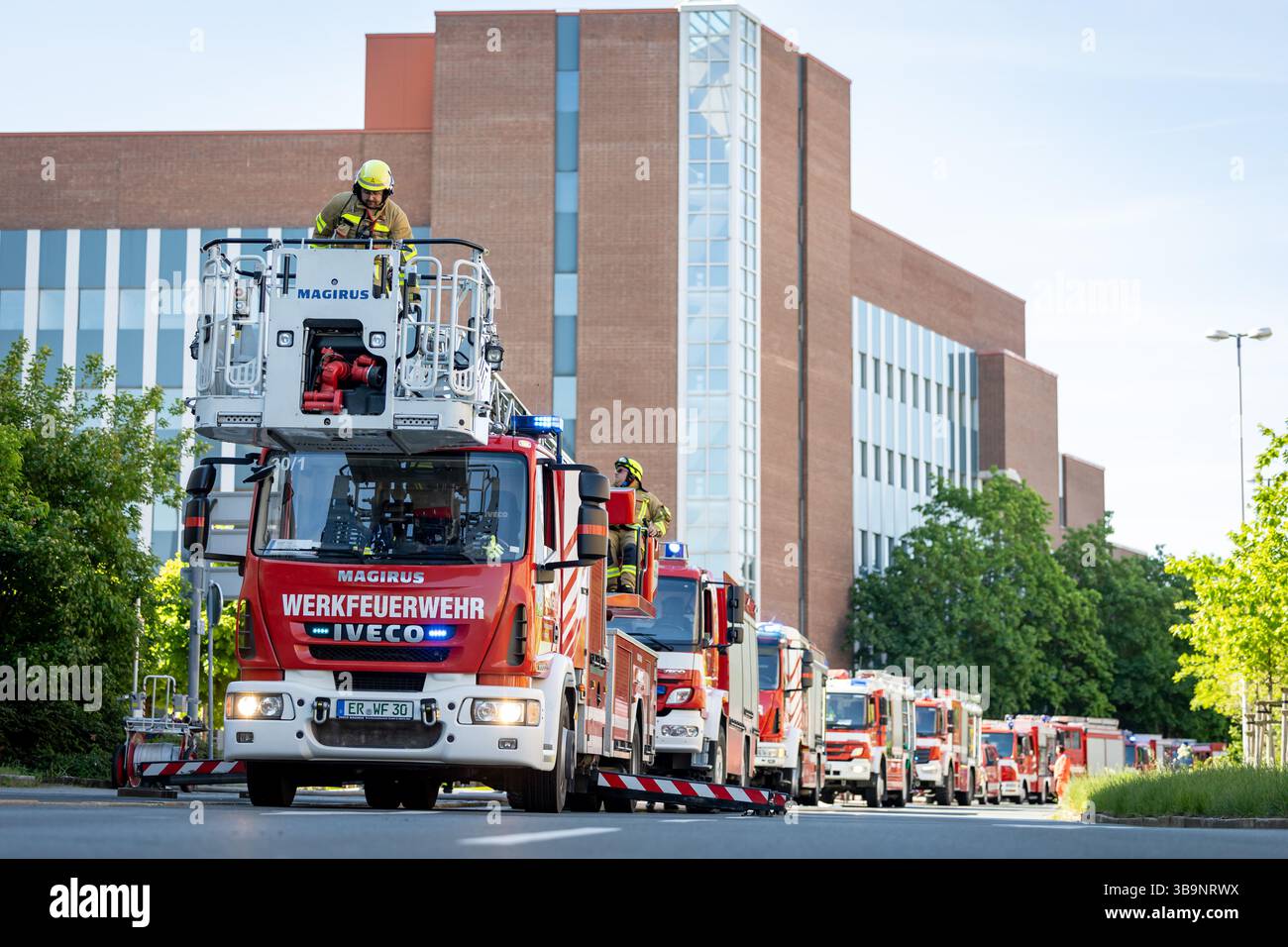 10 May 2025, Bavaria, Erlangen: Fire engines stand in front of a ...