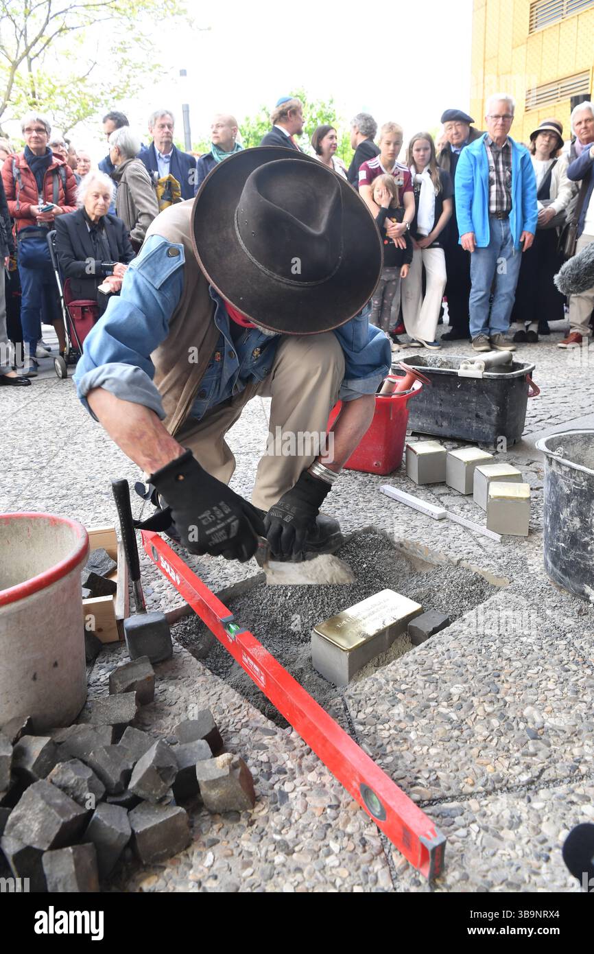 Berlin, Germany. 10th May, 2025. The artist Gunter Demnig lays ...