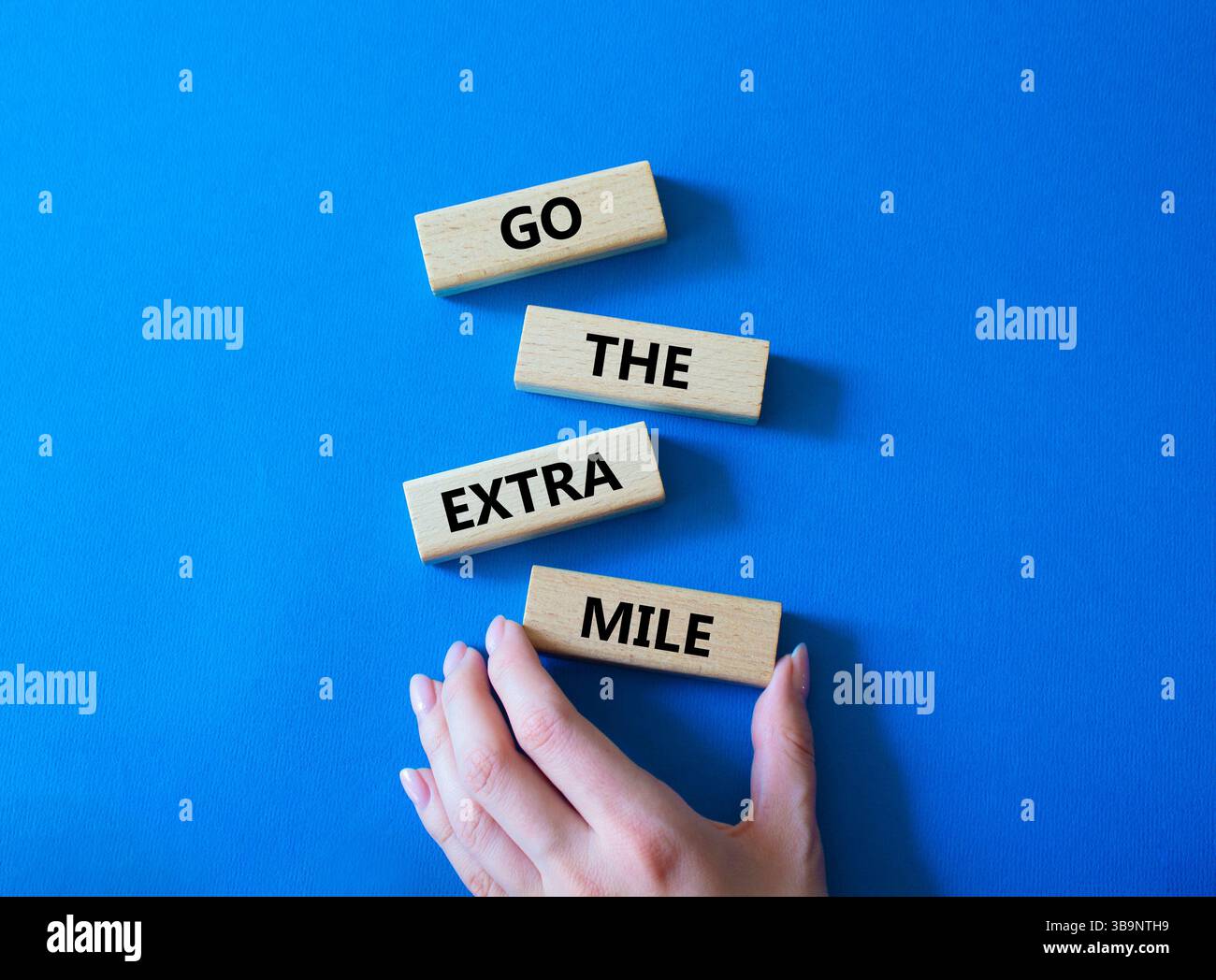Go the extra mile symbol. Wooden blocks with words Go the extra mile ...