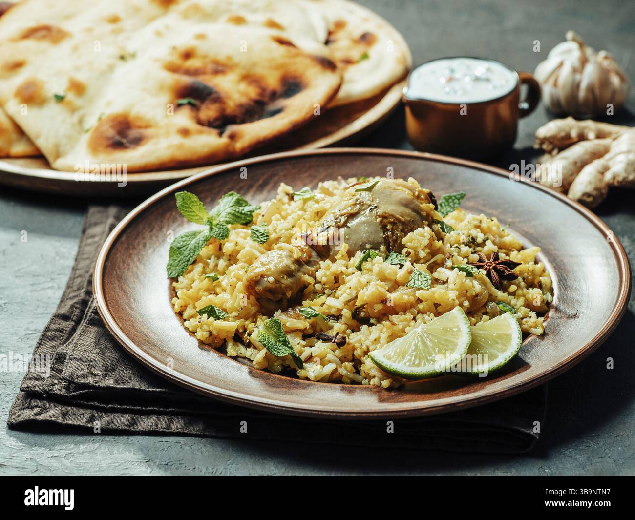 Pakistani food - biryani rice with chicken, raita yoghurt dip and naan ...