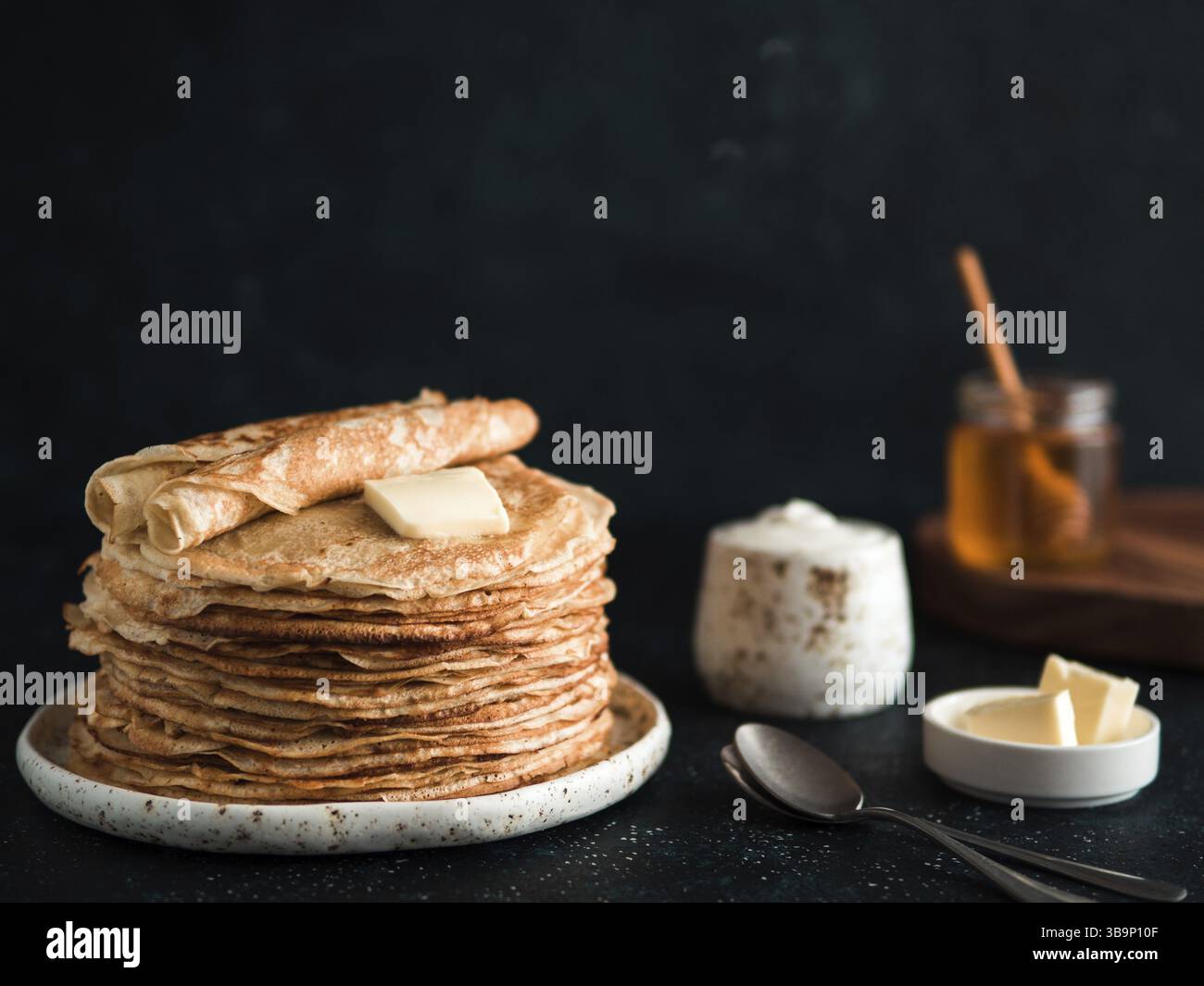 Stack of traditional russian pancakes blini on black background with ...