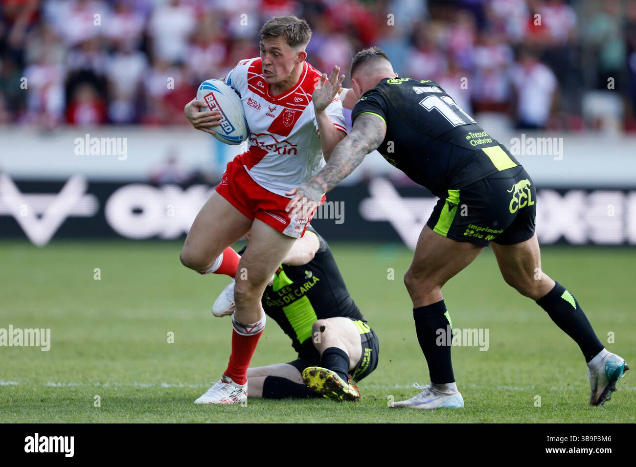 Hull KR's Jack Broadbent (left) is tackled by Catalans Dragons' Luke ...