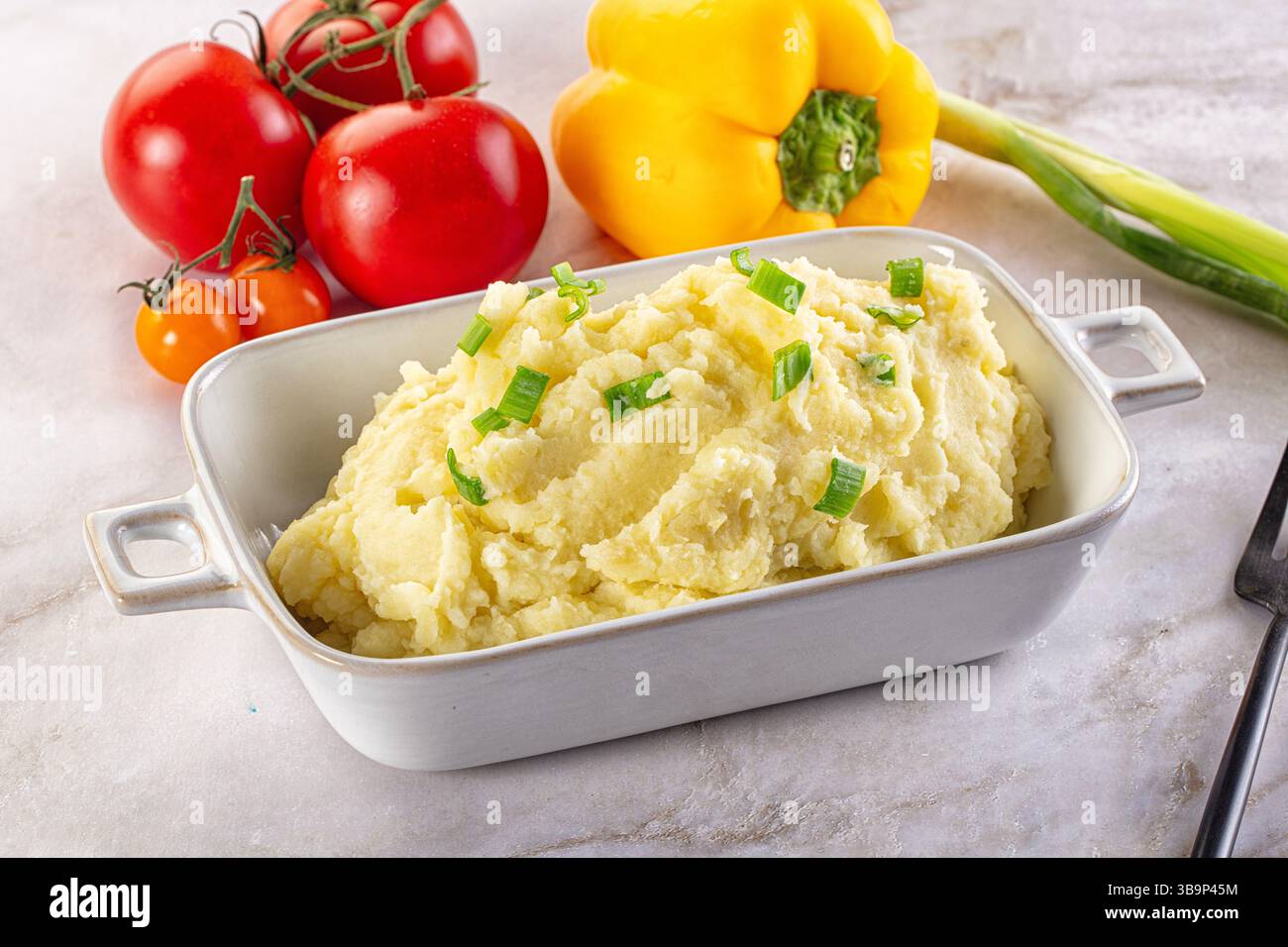 Mashed potato Puree with green onion garnish Stock Photo - Alamy