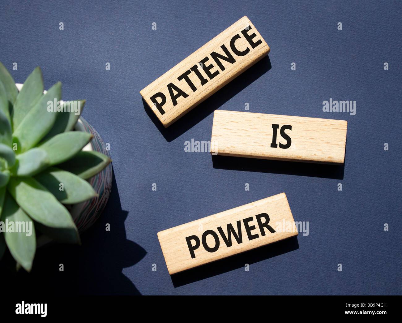 Patience is Power symbol. Concept words Patience is Power on wooden blocks. Beautiful deep blue ...