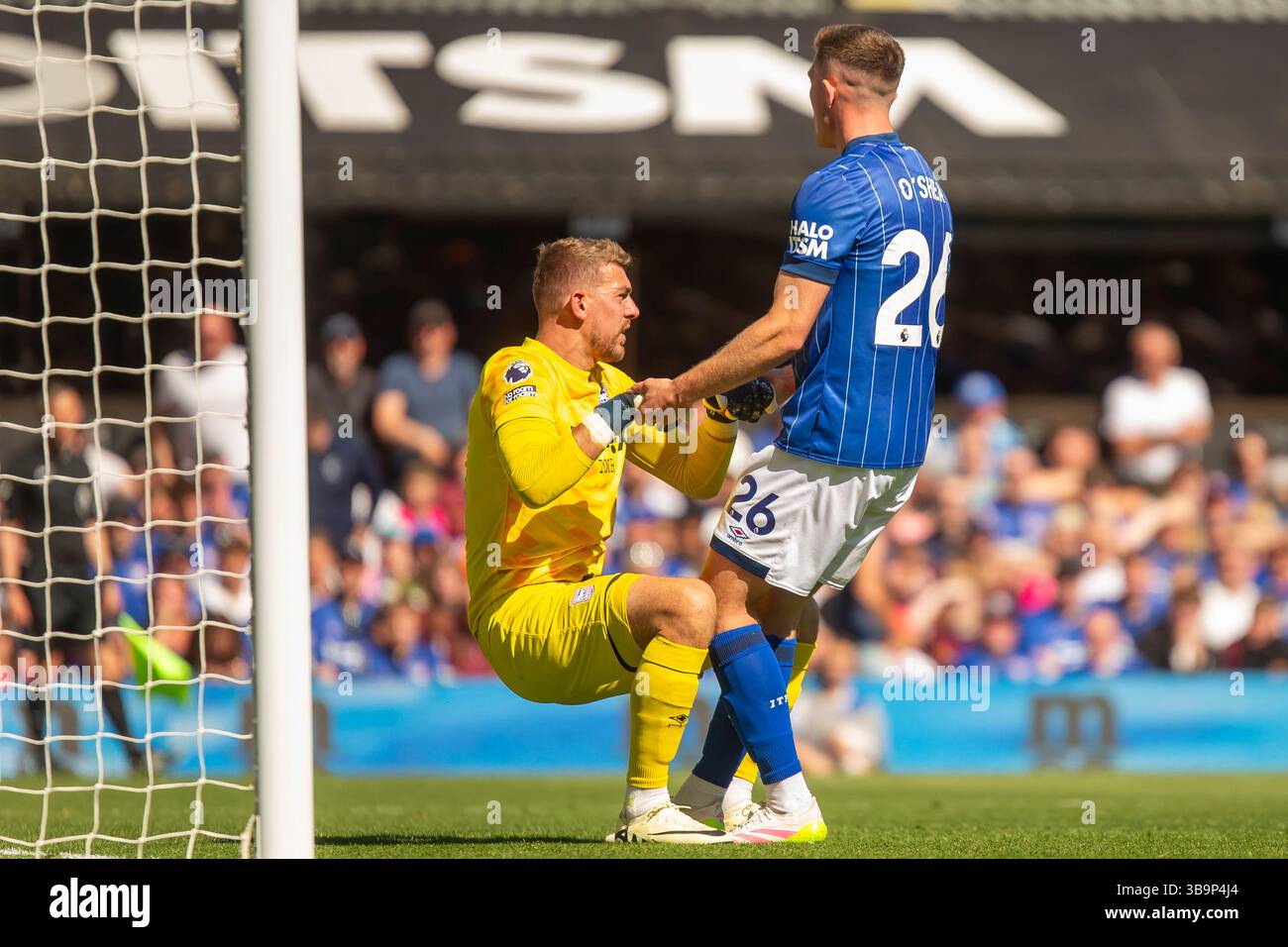 Alex Palmer of Ipswich Town is helped up by Dara O'Shea of Ipswich Town ...