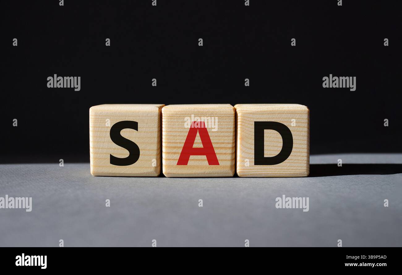 Sad symbol. Wooden cubes with words Sad. Beautiful grey background ...