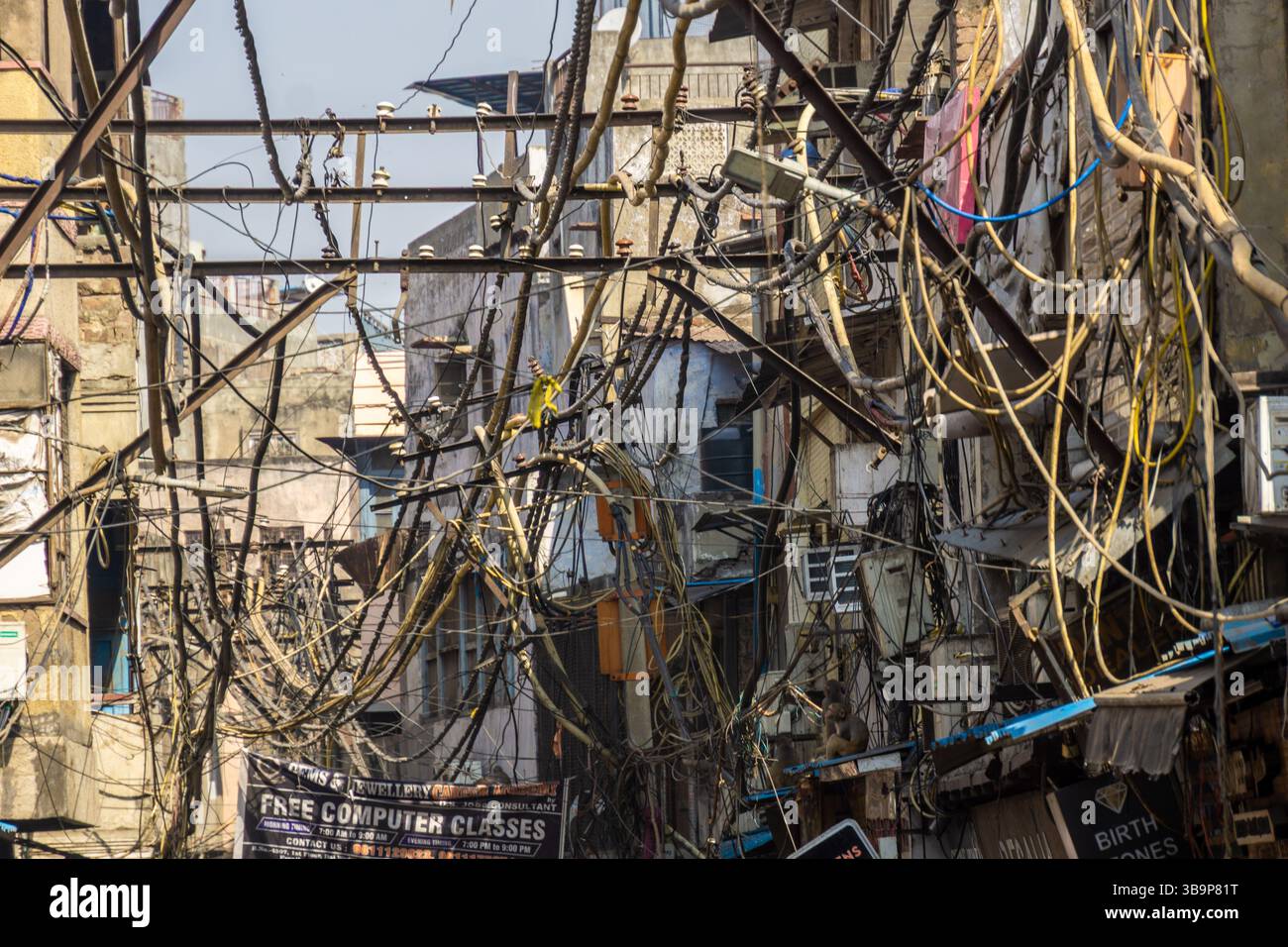 Chaotic overhead wiring and supports proliferate above the narrow ...