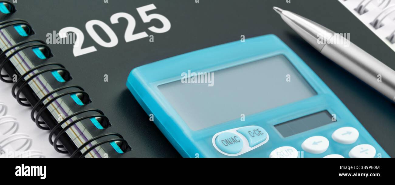 Blue calculator and calendar 2025 with pen Stock Photo - Alamy