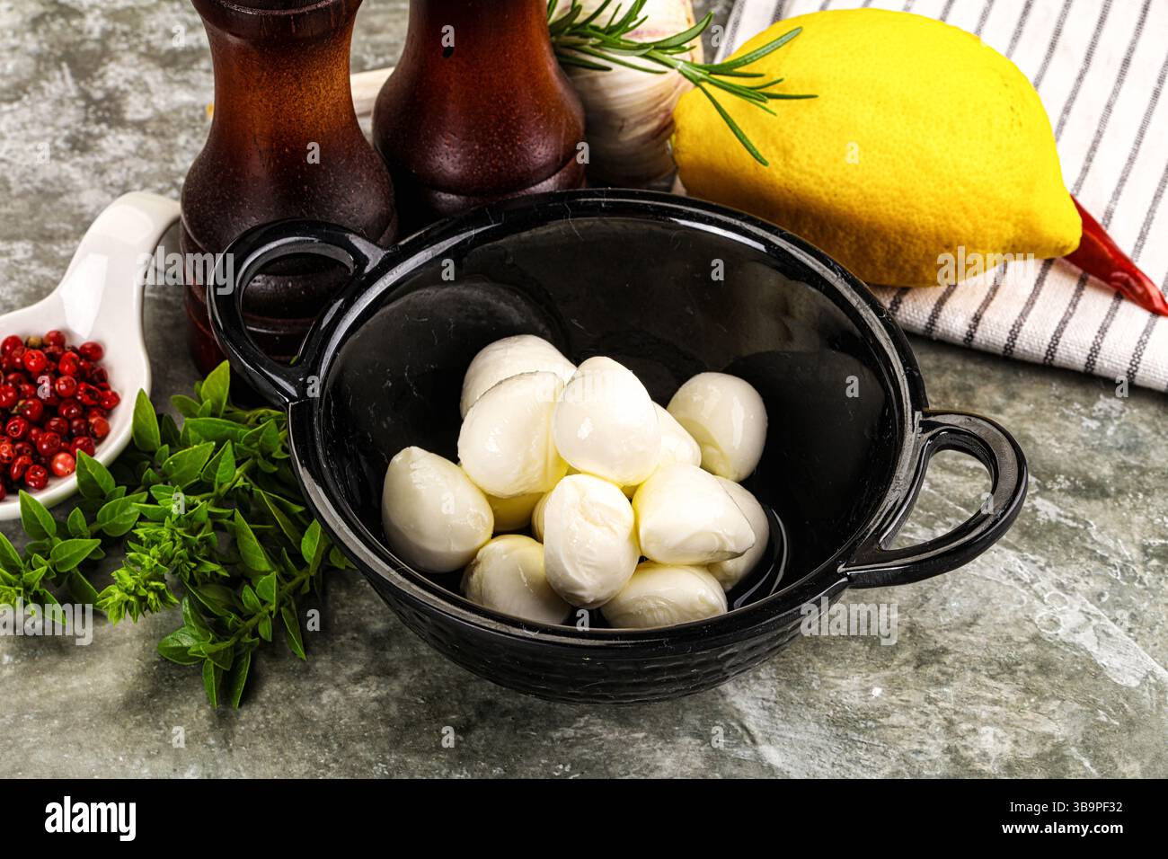 Small mozzarella mini cheese balls served basil Stock Photo - Alamy