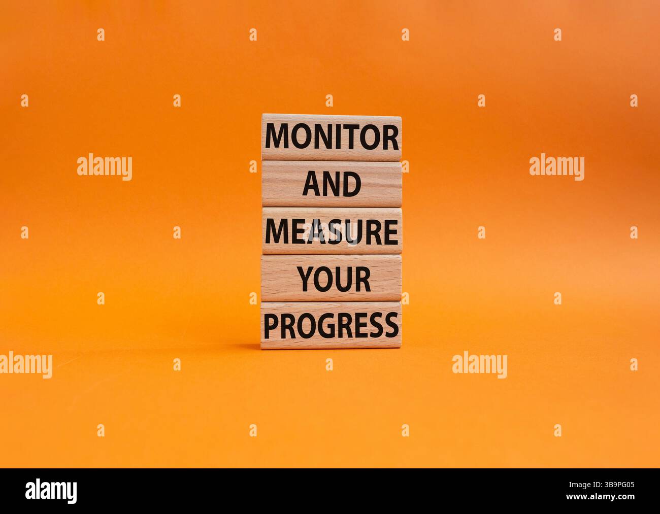 Monitor and Measure your Progress symbol. Wooden blocks with words ...