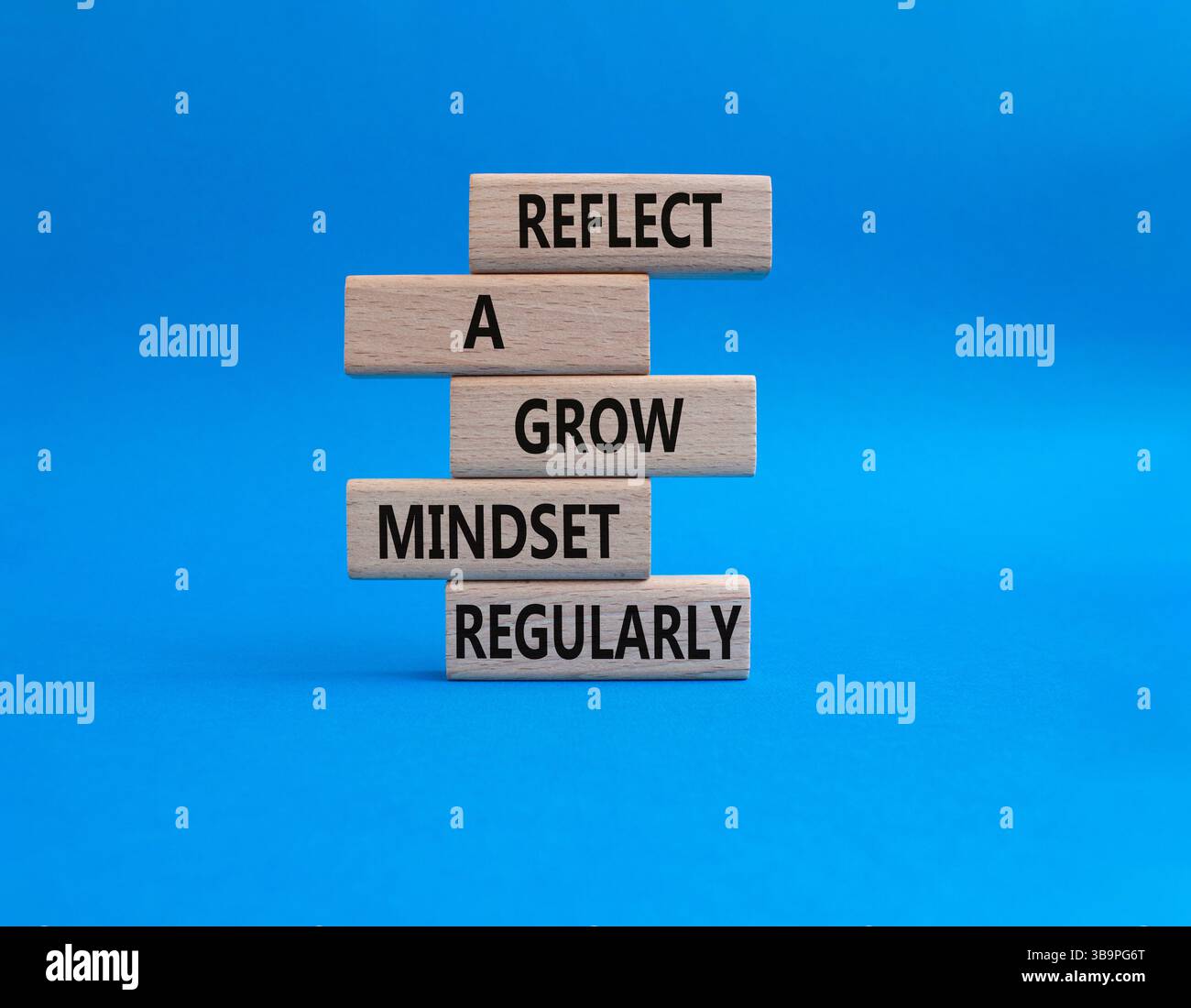 Refclect a grow mindset regularly symbol. Wooden blocks with words ...