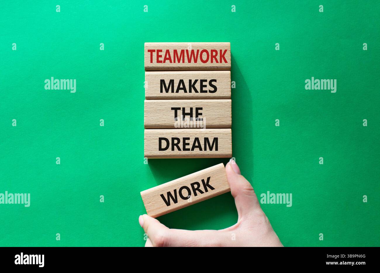 Teamwork symbol. Wooden blocks with words Teamwork makes the Dream work ...