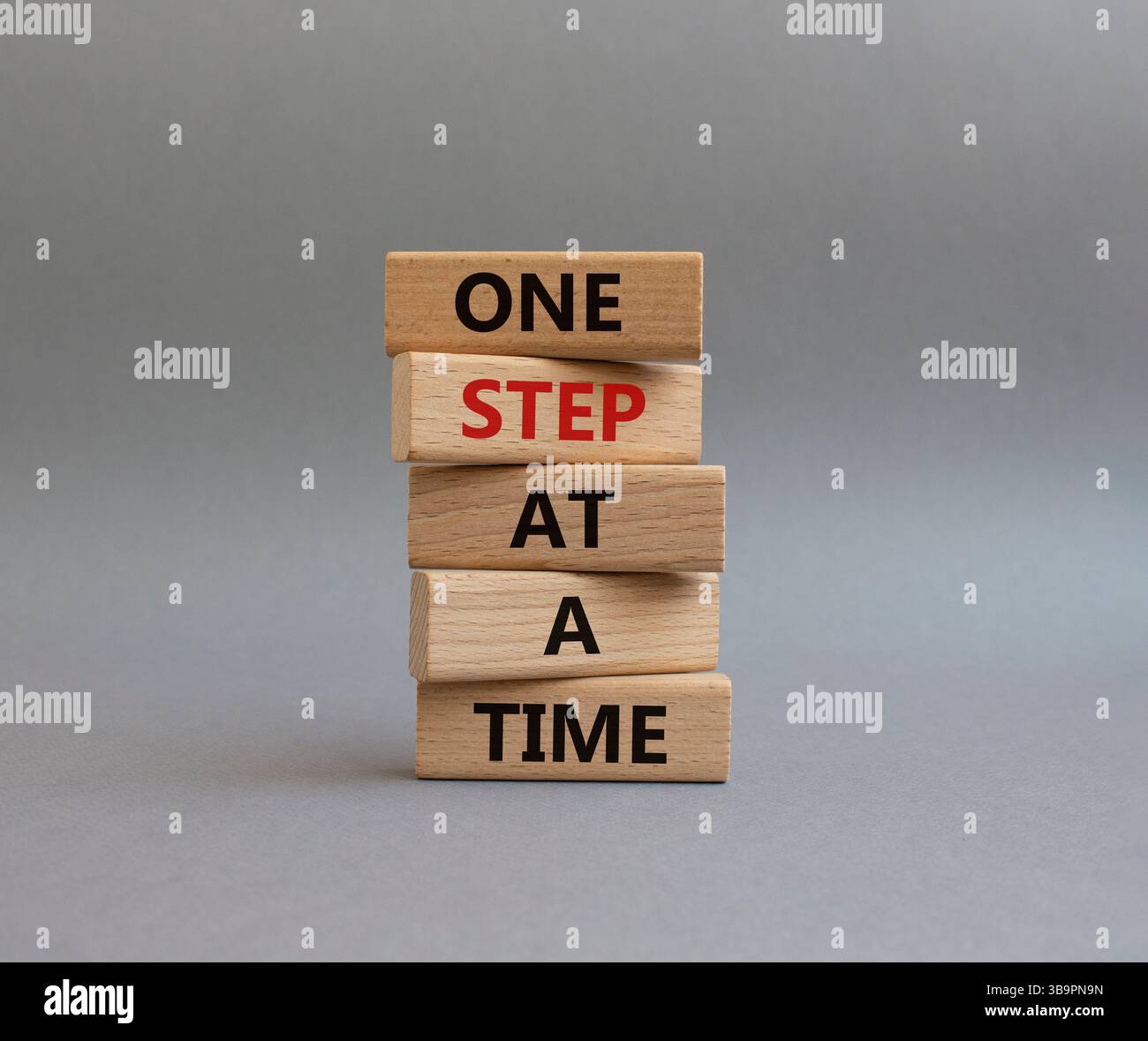 One step at a time symbol. Concept words One step at a time on wooden ...