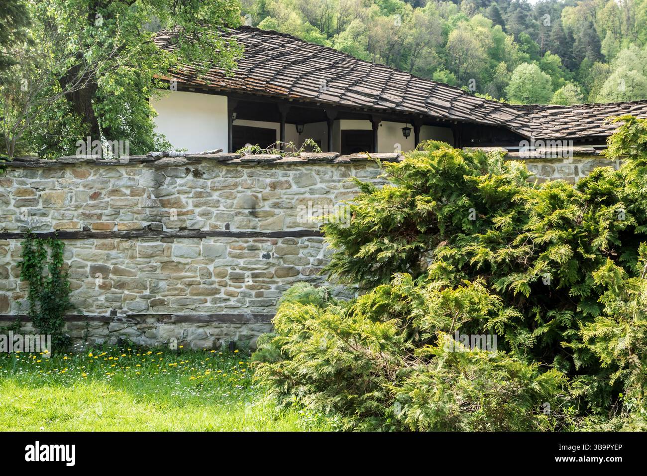 Old traditional house behind stone wall in Balkan country village in ...