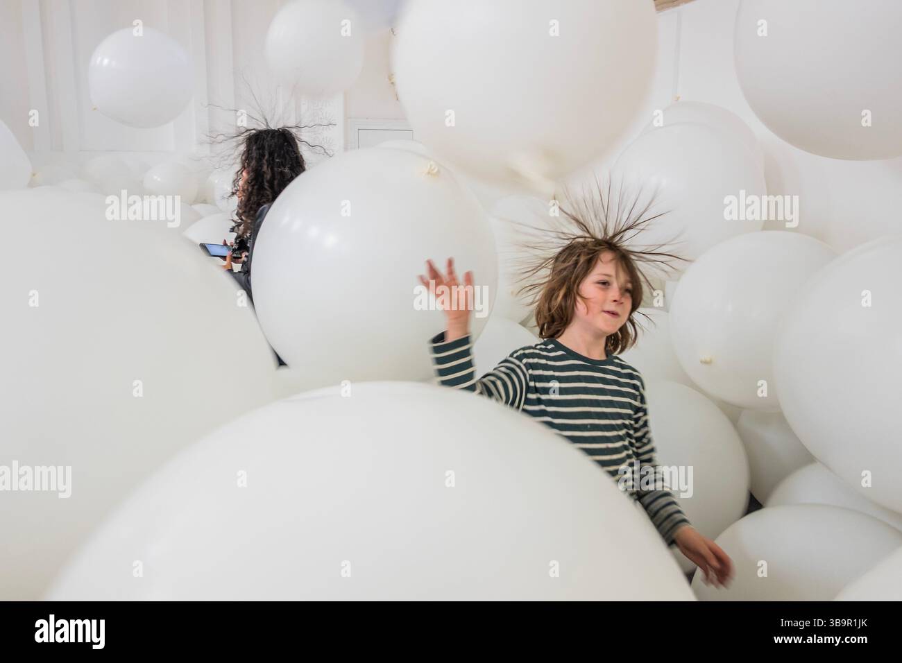 London, UK. 10 May 2025. Static makes hair stand on end, as people ...