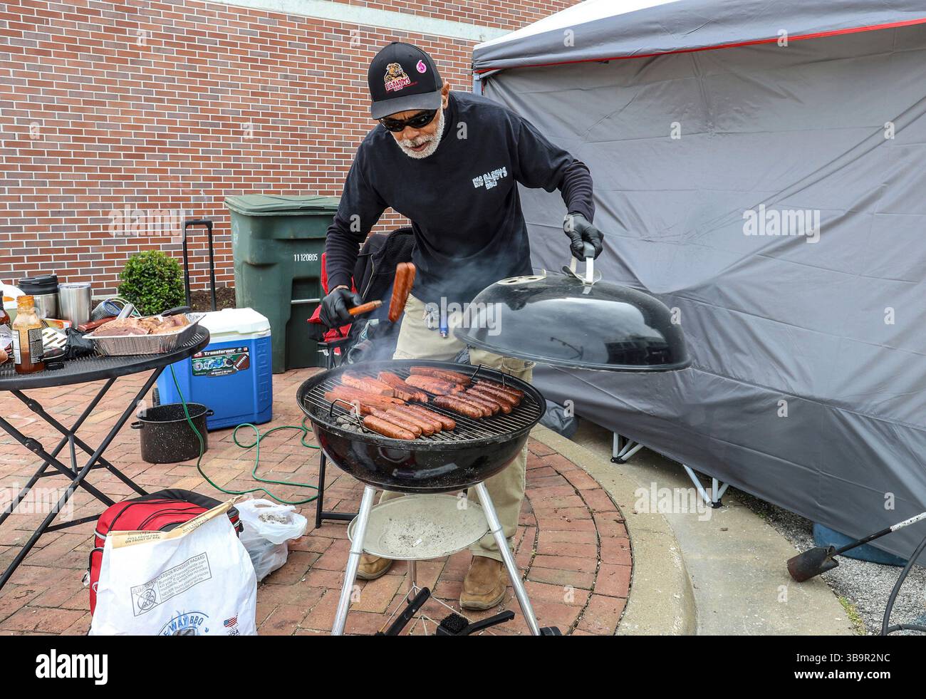Ron Gossom cooks jalapeno sausages on a grill while cooking with Big Daddy's BBQ in the Backyard ...