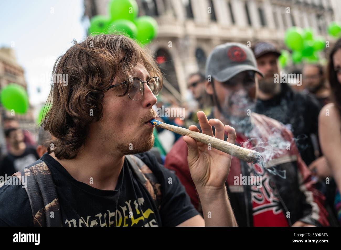 Madrid, Spain. 10th May, 2025. A man is seen smoking a large joint ...