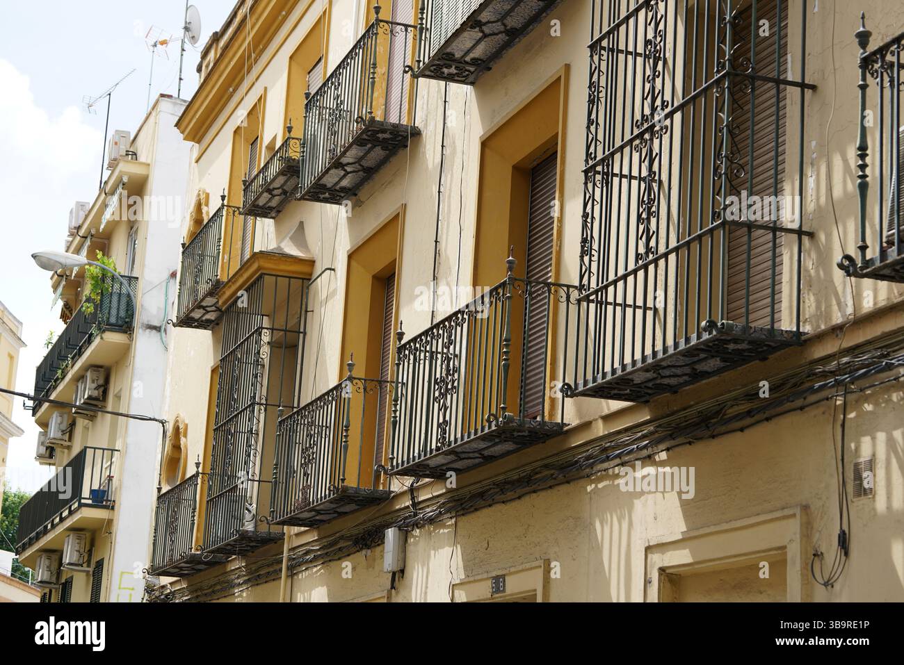 Traditional apartment building facade with wrought-iron balconies and ...
