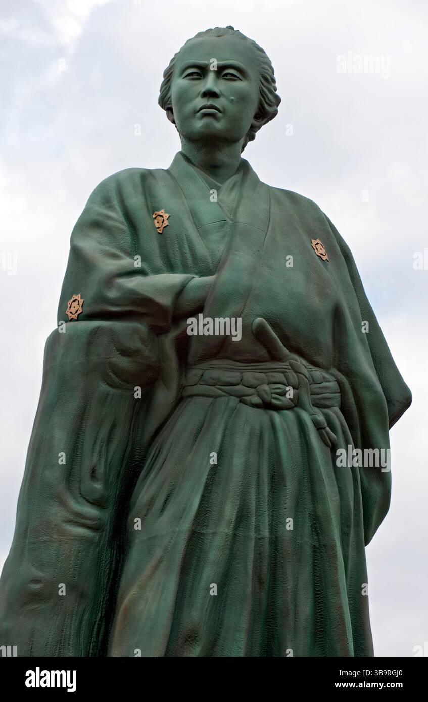 Bronze statue of Tosa samurai warrior Sakamoto Ryoma standing in front of Kochi Station in ...