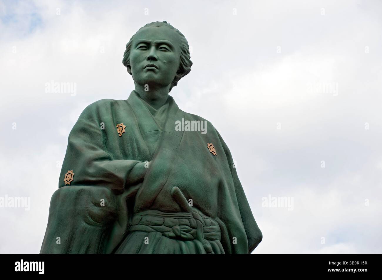 Bronze statue of Tosa samurai warrior Sakamoto Ryoma standing in front of Kochi Station in ...