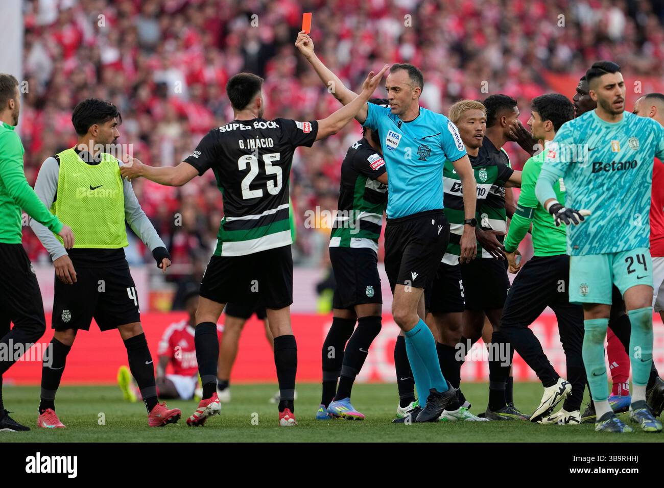 Referee Joao Pinheiro shows a red card to Sporting's Ricardo Esgaio ...