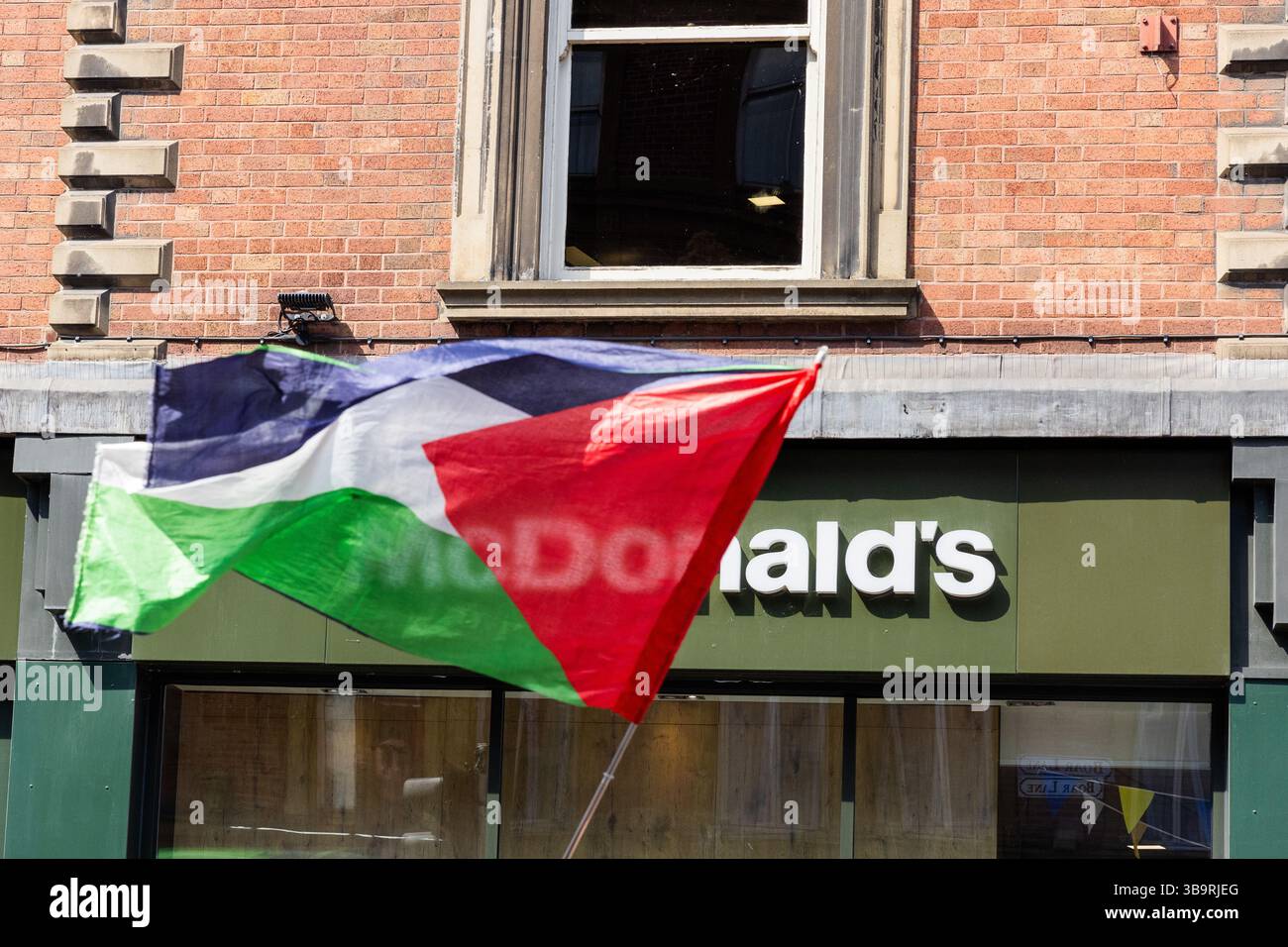Leeds, UK. 10 MAY, 2025. Palestine flag flies in front of Boycott ...