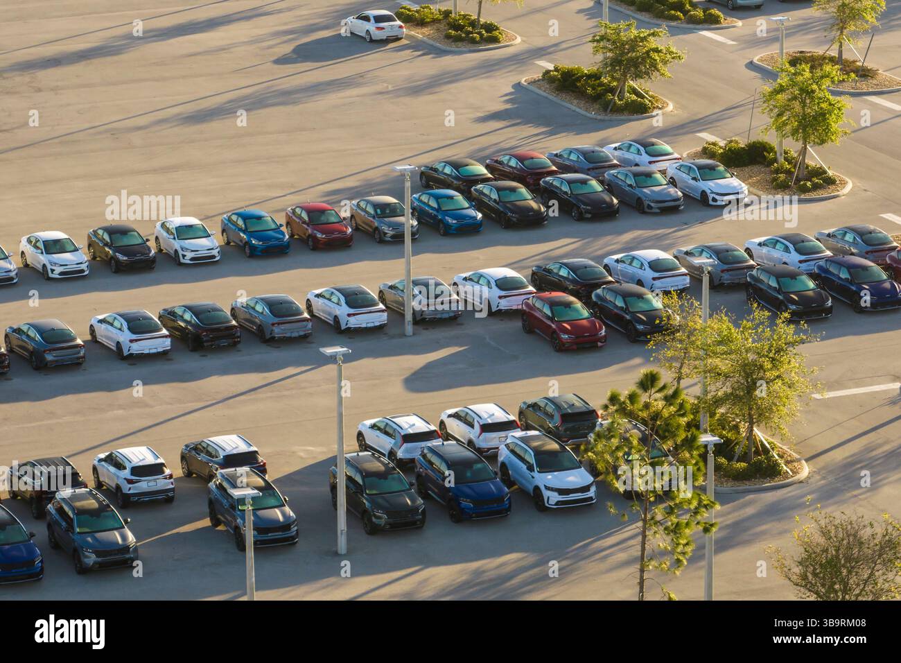 Aerial view of dealership parking lot with many brand new cars for sale ...