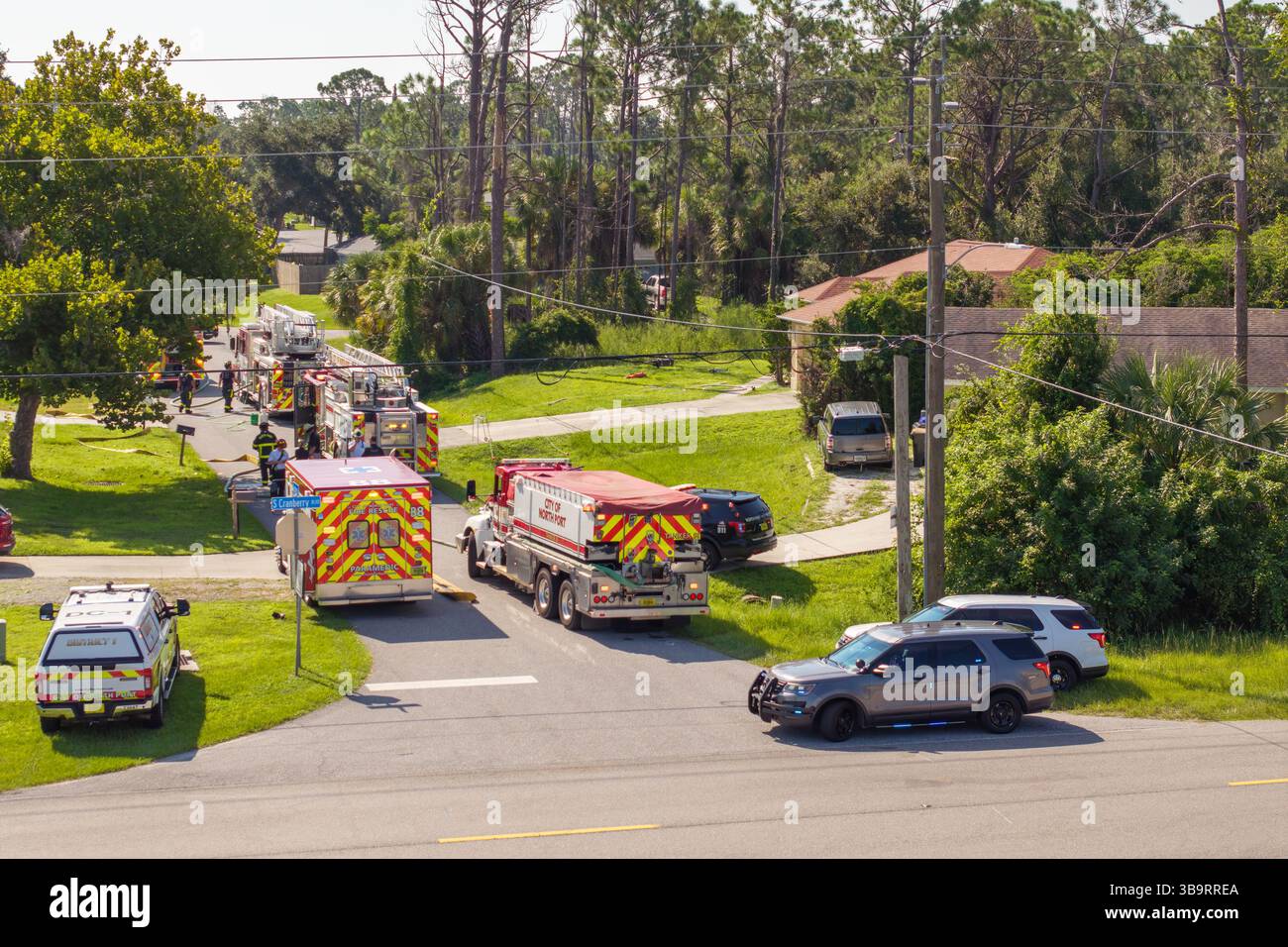 Firefighter trucks at fire alarm scene of suburban house. First ...