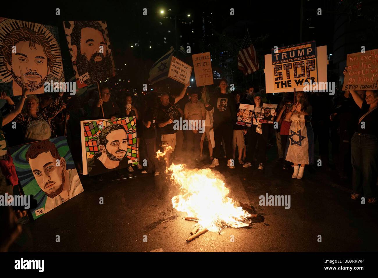 Demonstrators light a bonfire during a protest demanding a cease-fire ...