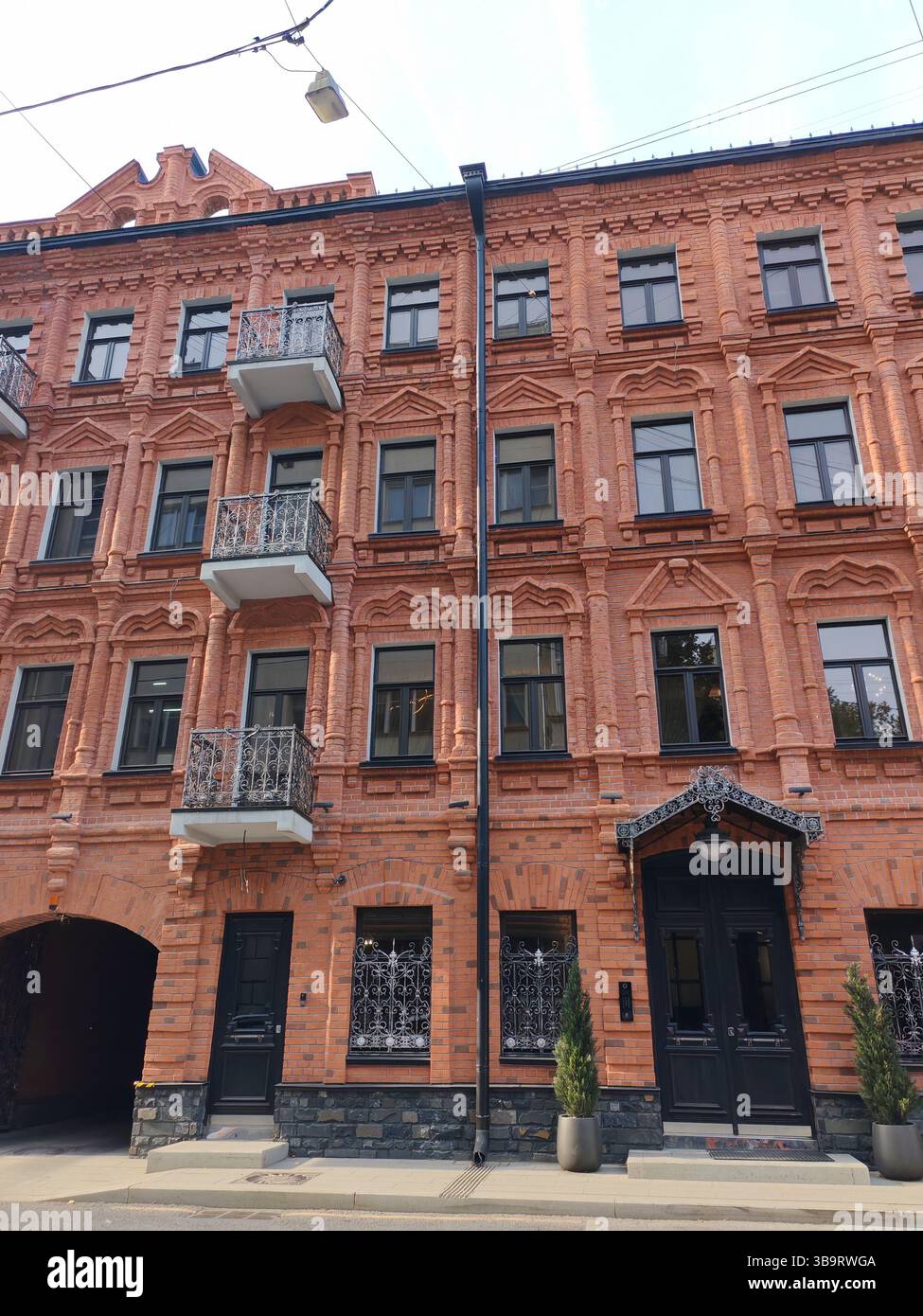 A tall red brick building featuring elaborate decorative elements ...