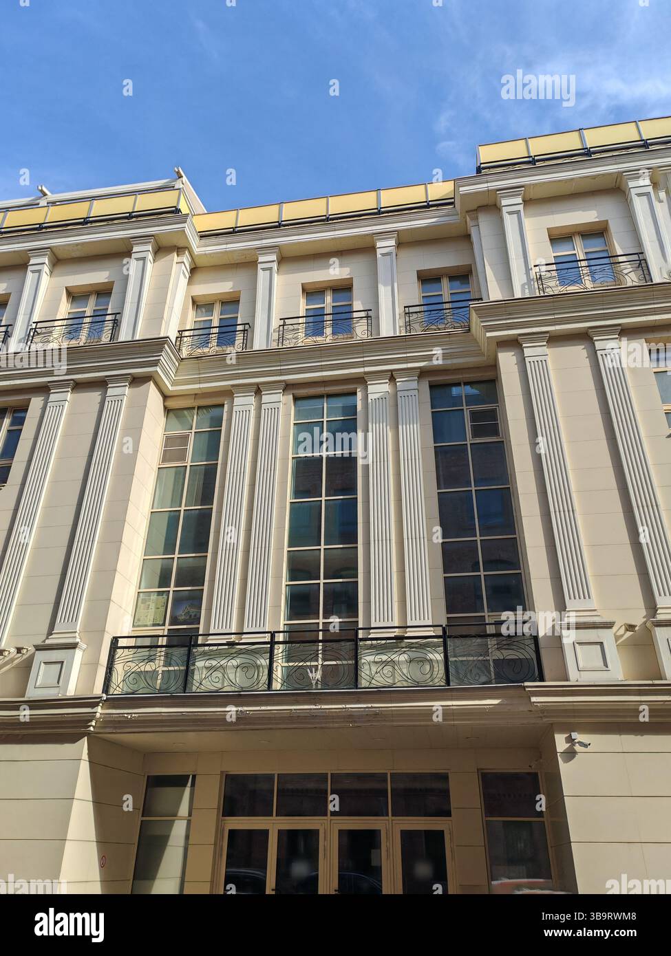 Elegant cream-colored building featuring symmetrical columns and ...