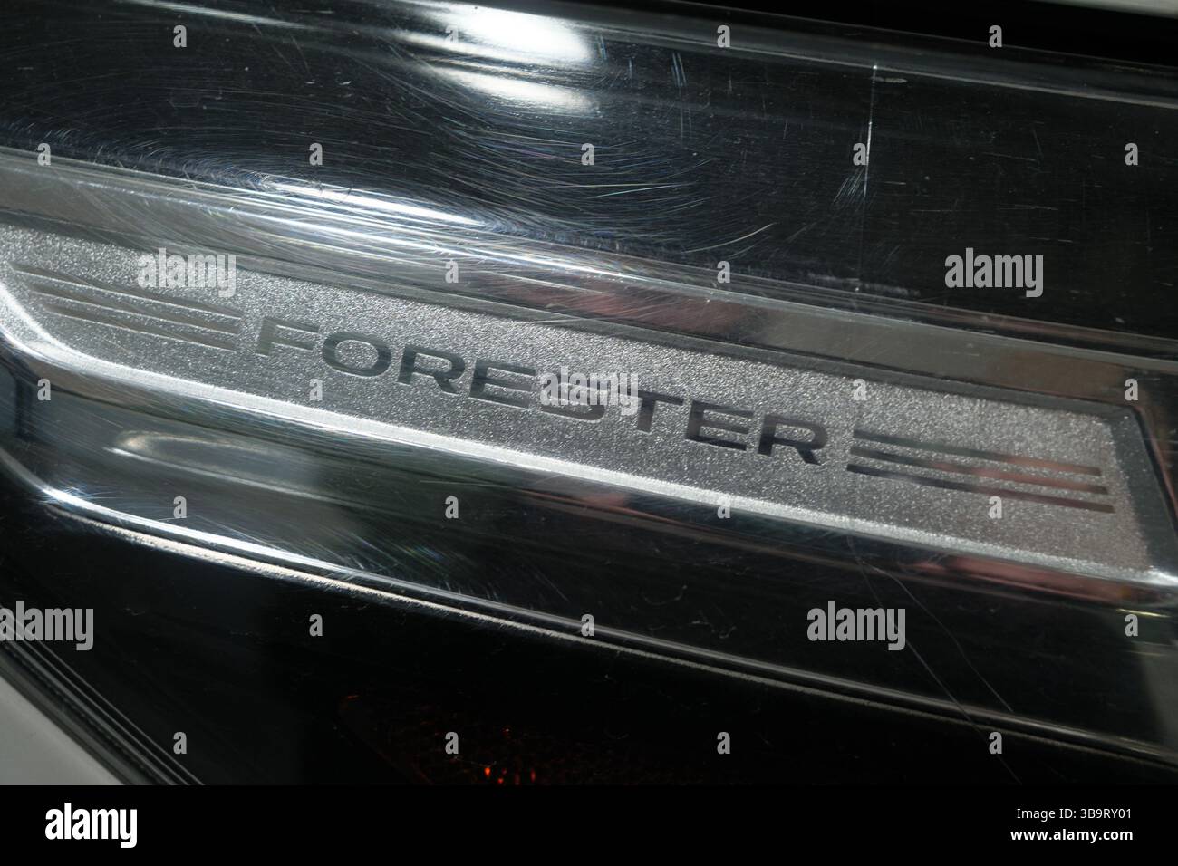 Metallic Subaru Forester logo gleaming on polished vehicle headlight ...