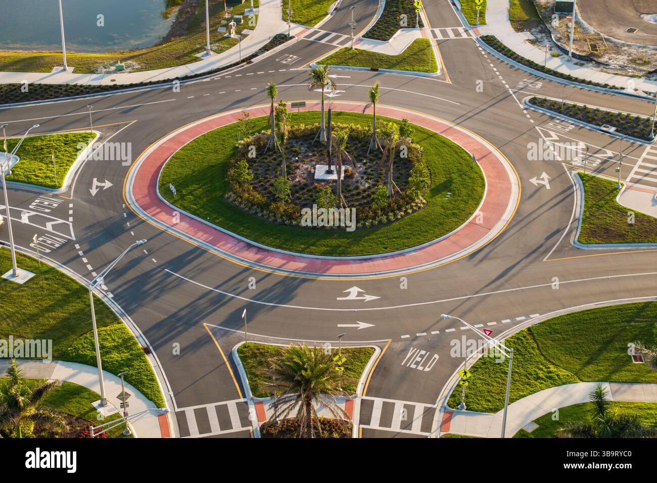 Traffic circle on American road with driving cars. Overhead view of US roundabout intersection ...